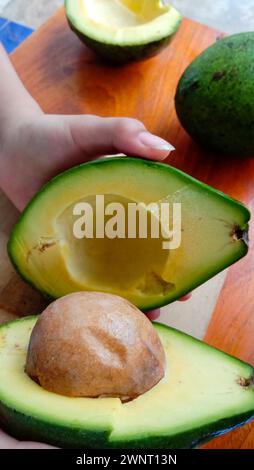 A photo of an avocado that has been split on a table Stock Photo - Alamy