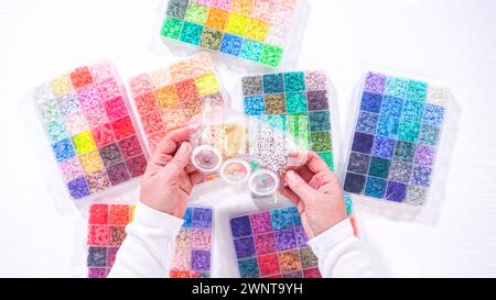Woman's Hands Amidst a Rainbow Array of Beads for Jewelry Crafting ...