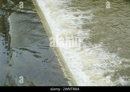 A fast-flowing stream and dramatic lenticular clouds against a dark sky ...