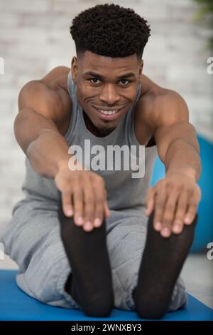 handsome young man doing hamstring stretch exercise Stock Photo - Alamy