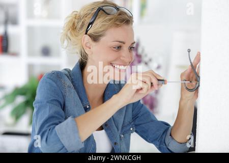 pretty young woman doing diy work at home Stock Photo - Alamy