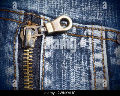 Close-up denim with seams and locks. Heavily shabby worn jeans. Metal ...
