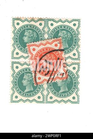 A montage of vintage Queen Victoria halfpenny postage stamps from Great Britain isolated on a ...