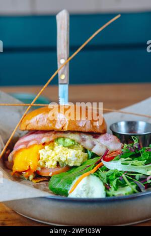 Homemade Broccoli Bacon Salad on a Plate on a black background, side ...