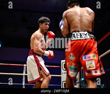 Subaru Murata (red gloves) of Japan and Alex Santisima Jr. (blue gloves) of the Philippines ...
