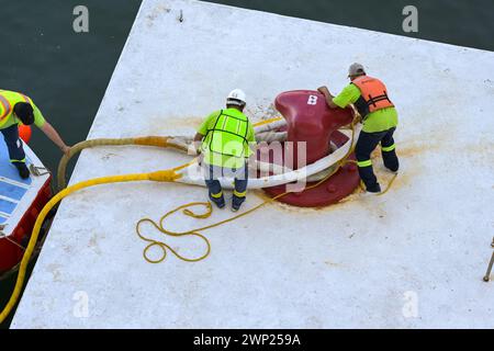 Aerial view motorboat & mooring crew release cruise ship hawsers fixed ...