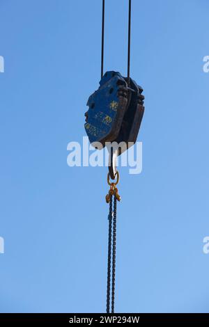 Mobile crane lifting block, wire ropes and chains with blue sky in ...
