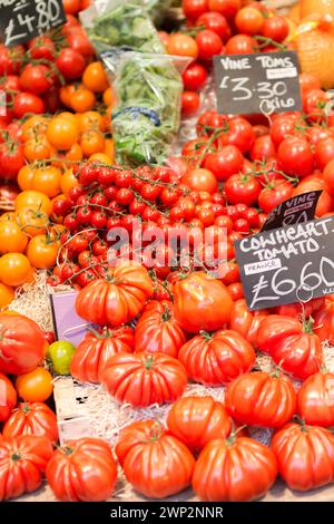 Tomatoes at the market display stall Stock Photo - Alamy