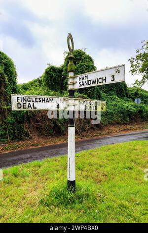 Old moss-covered signposts in the countryside, showing direction and ...