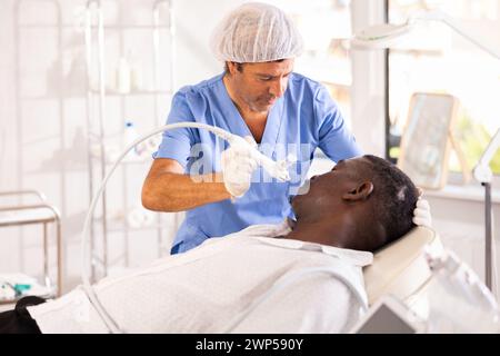 cosmetologist enhanced client's complexion Stock Photo - Alamy