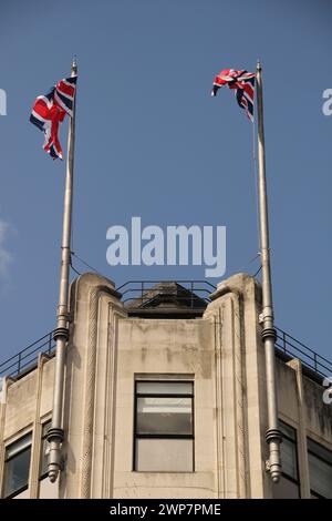Some Union Jack flags in London waving on a building in sunlight Stock ...