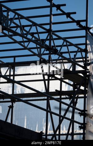 Scaffolding and tarpaulins - at a construction site for a new factory ...