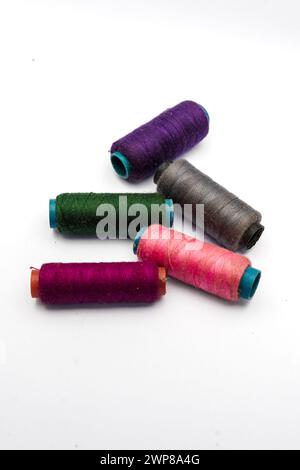Multicolor sewing threads background isolated on white Stock Photo - Alamy