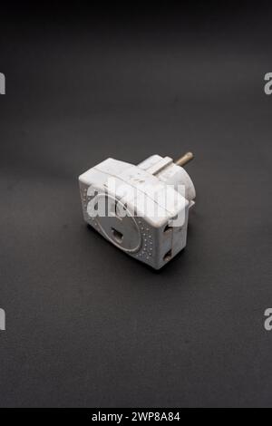 Dirty used triple outlet tap. Electric energy adapter used to split ...