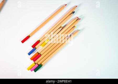 A pile of colorful pencils stacked together on a white background Stock ...