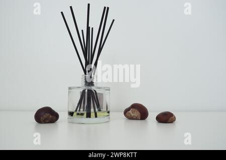 Incense sticks are dipped into a glass cubic vessel with essential oils ...