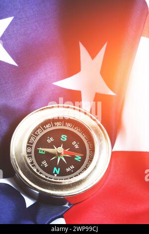 Compass pointing west and star spangled flag United States America ...
