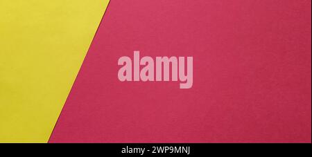 A yellow sheet of paper is laid sideways on a red sheet of paper. Thick ...