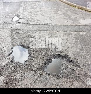 Potholes on an english road Stock Photo - Alamy