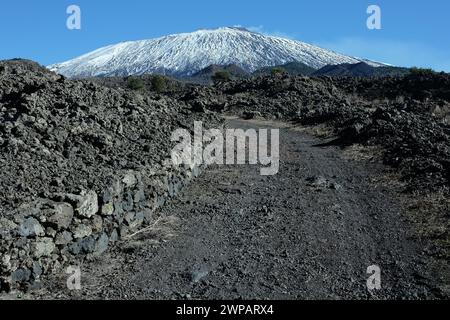 path through leaden-blue color of basalt volcano rock of Mount Etna in ...