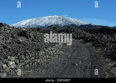 path through leaden-blue color of basalt volcano rock of Mount Etna in ...