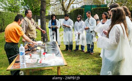 The instructor speaks to a group of veterinary students at an outdoor ...