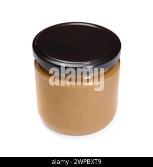 Tasty nut paste in jar, spoon and pistachios isolated on white Stock ...