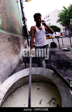 A cook cooking biryanis in a large communal cooking space during the ...