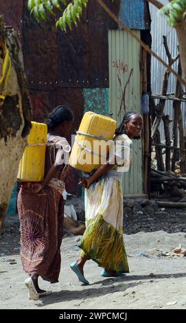 Tigrayan women carrying water to their village in large jerrycans ...