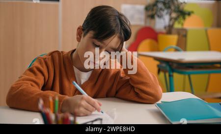 Boy thinking hard about how solve his homework with Stock Photo - Alamy