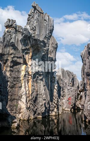 Dramatic Karst limestone geologic formations rising from lake in Stone ...