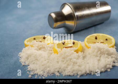 Lemon slices with cloves and cinnamon forming a smiley face on a pile ...