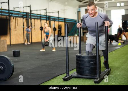 Man during grueling workout with element of push and pull superset in ...