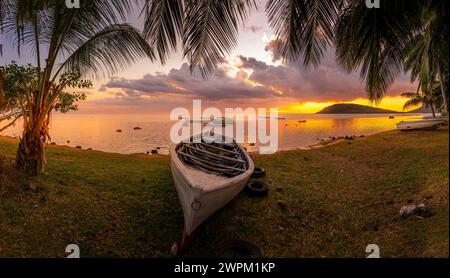 View of Le Morne through palm trees at Le Morne Brabant at sunset ...