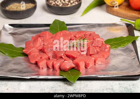 Beef cubed meat. Butcher products. Chopped raw beef on stone background ...