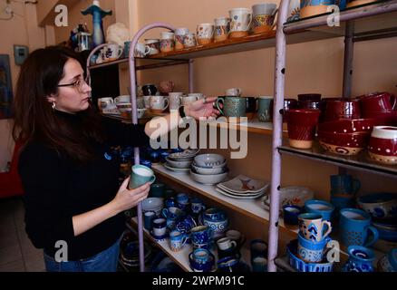 Damascus, Syria. 18th Jan, 2024. Rama Saman crafts a vase out of clay ...