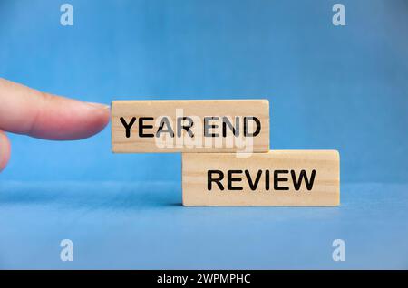 Finger pointing Mid Term Review text on wooden block with blue ...