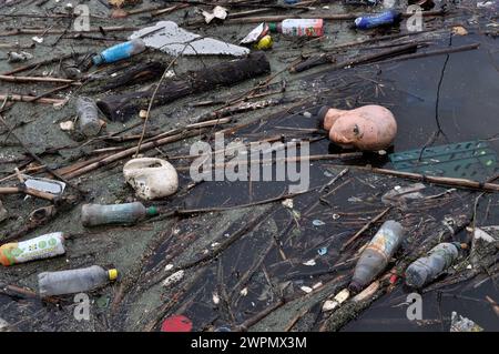 Detritus including plastic head etc floating on water at Salford Quays ...