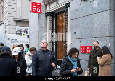 Shoppers and pedestrians walk past the Japanese clothing brand store ...