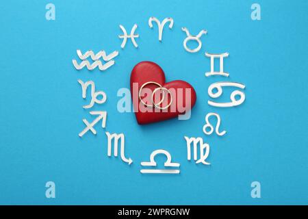 Zodiac signs and heart on light blue background, flat lay Stock Photo ...