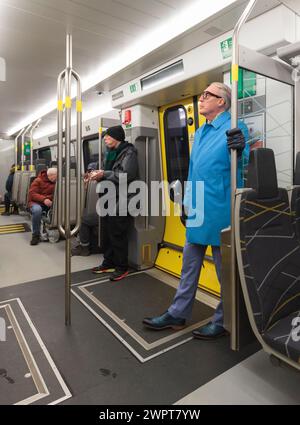 Passengers standing by the doors in a Merseyrail class 777 train ...