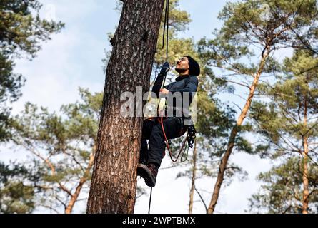 An activist pulls himself up a rope to one of the tree houses in the ...