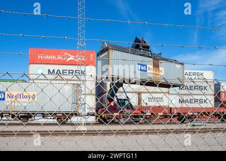 Loading of containers on railway wagons with a lifting crane at a ...
