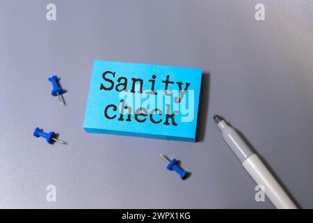 text Sanity check on white business card Stock Photo - Alamy