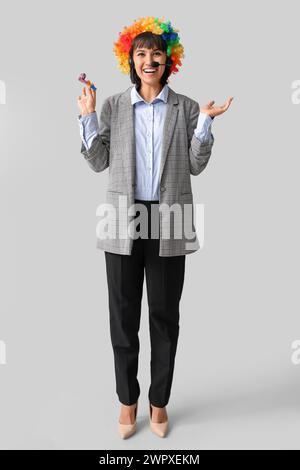 Funny young female technical support worker with headset and pig nose ...