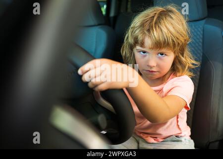 Little Driver. Cute little boy pretending to drive. Kid in car with his ...