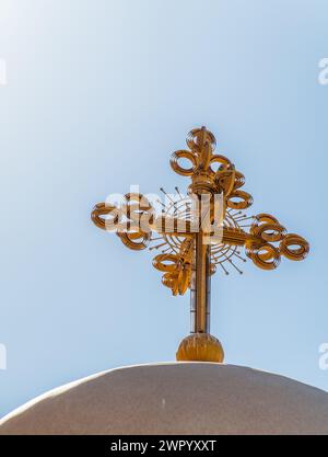 Christian cross on a mound against a blue sky with white clouds Stock ...