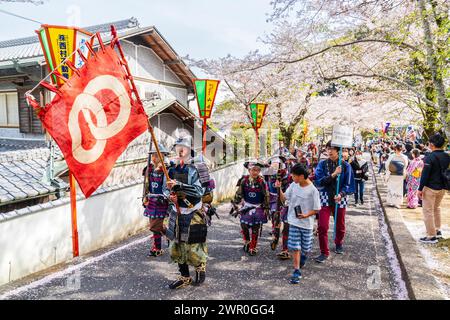 Tatsuno samurai parade under cherry blossom trees with two girls in ...