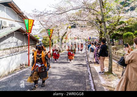 Tatsuno samurai parade under cherry blossom trees with two girls in ...