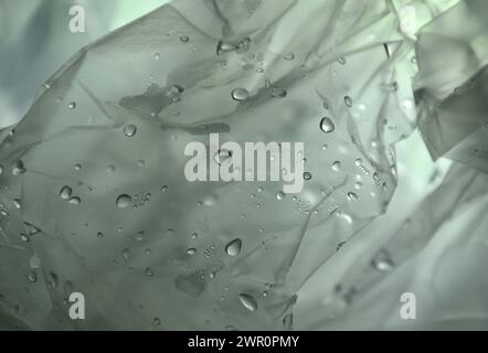 white plastic bag packing stacking with drop of water background and ...